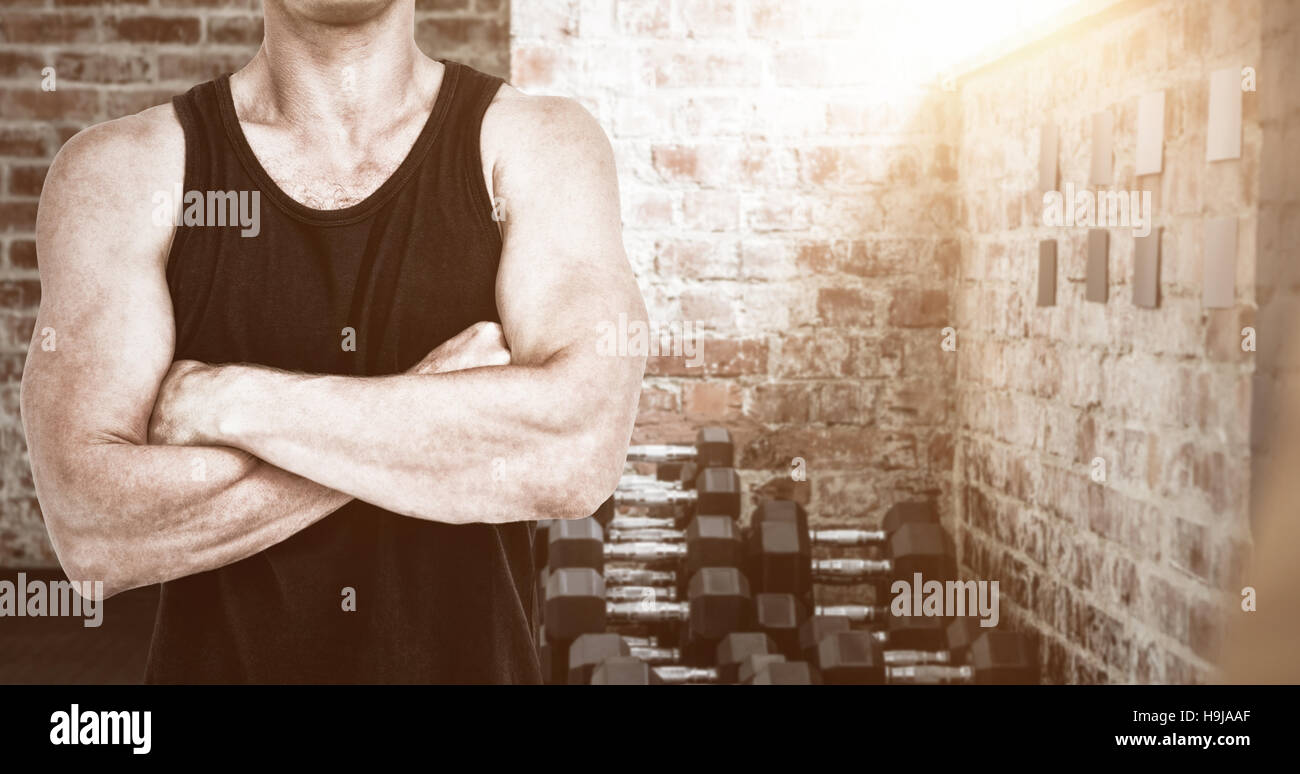 Composite image of athlete standing with arms crossed Stock Photo - Alamy