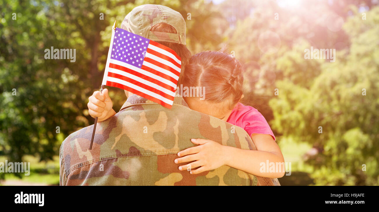 Army man hugging daughter with American flag Stock Photo - Alamy