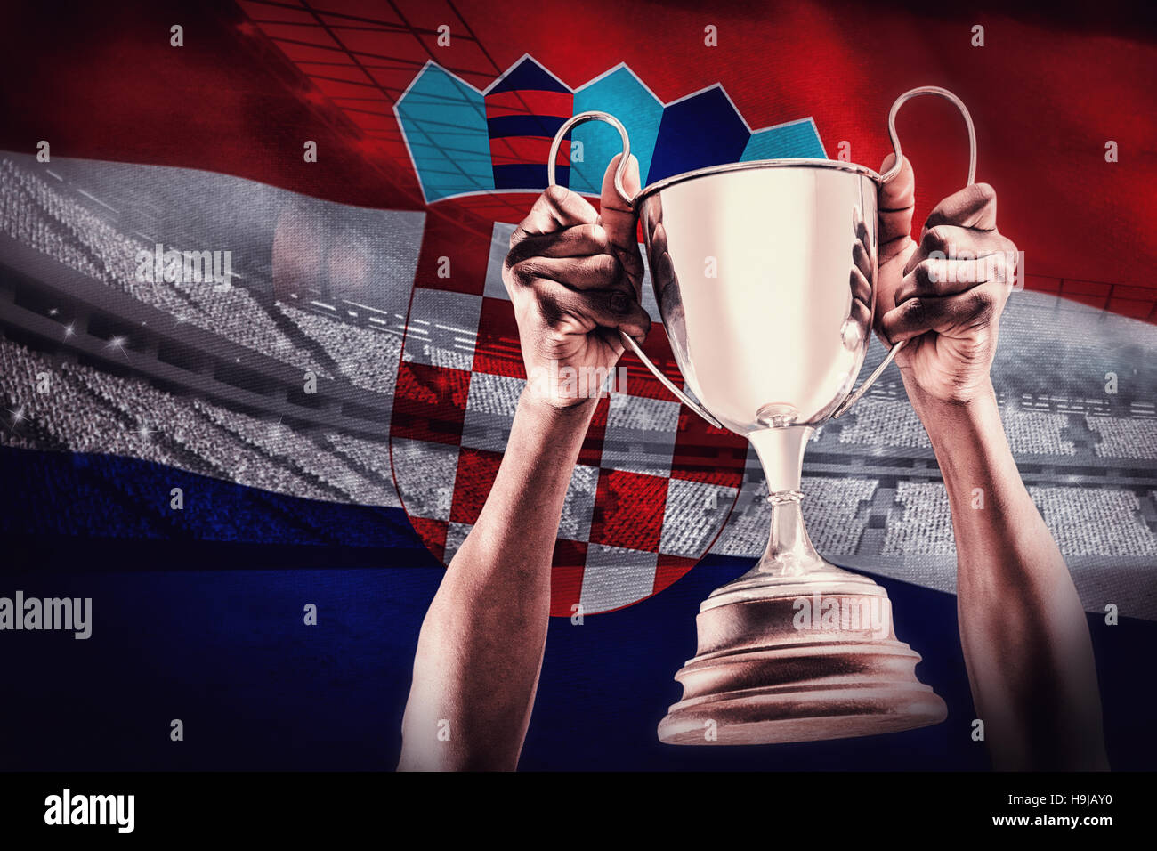 Composite image of happy athlete cheering while holding trophy Stock ...