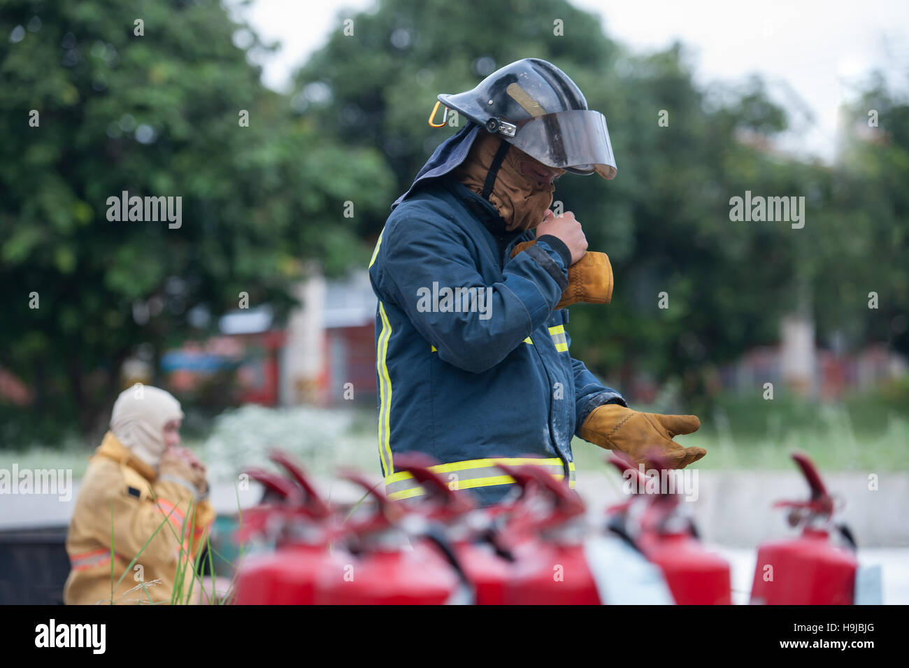 A firefighters dress their suit before the operating Stock Photo - Alamy