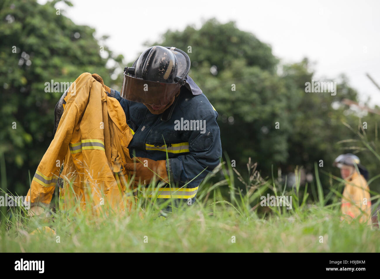 A firefighters dress their suit before the operating Stock Photo - Alamy