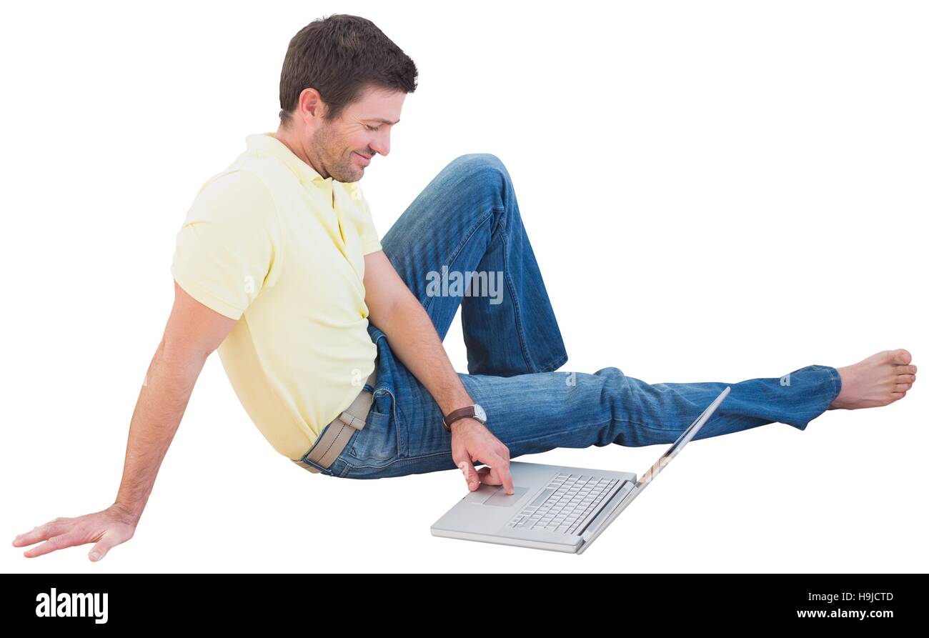 Smiling man using a laptop Stock Photo - Alamy