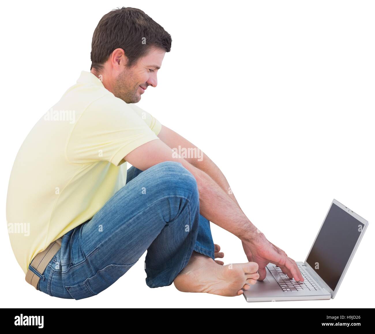 Smiling man using a laptop Stock Photo - Alamy