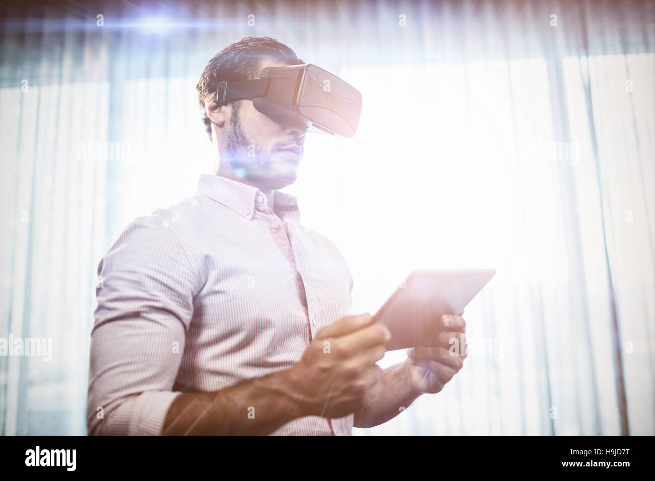 Businessman using an oculus Stock Photo - Alamy