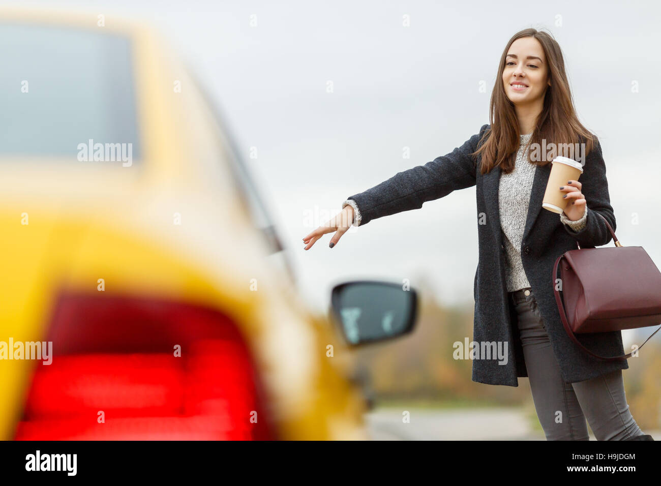 Woman on road stop taxi Stock Photo - Alamy