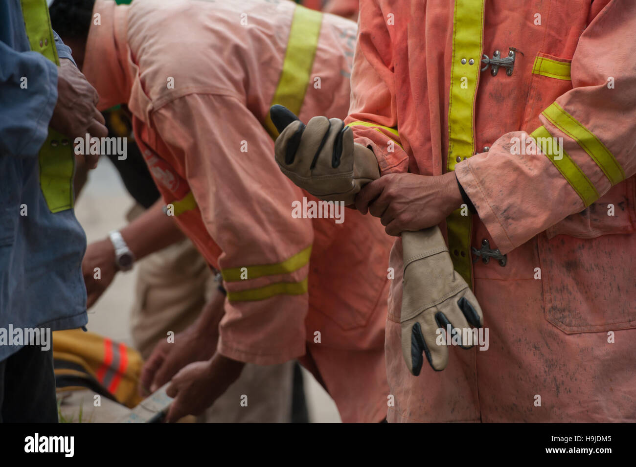A firefighters dress their suit before the operating Stock Photo - Alamy