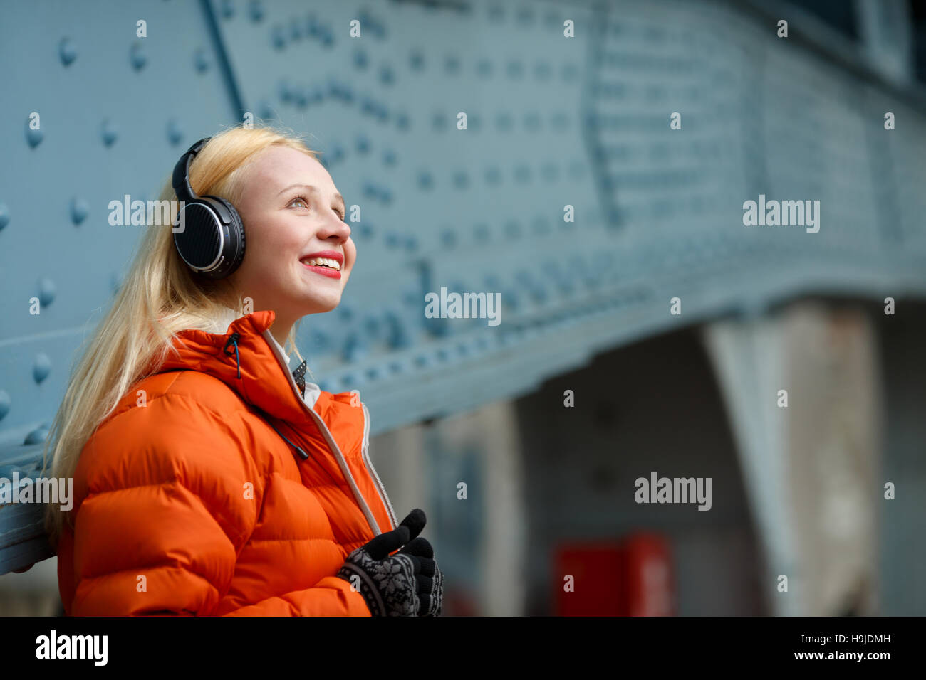 Ginger enjoying music on headphones Stock Photo - Alamy