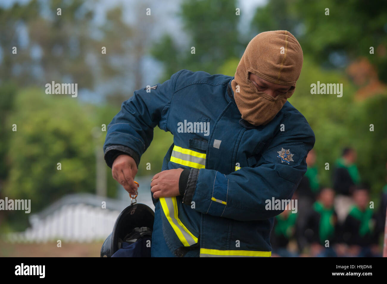A firefighters dress their suit before the operating Stock Photo - Alamy