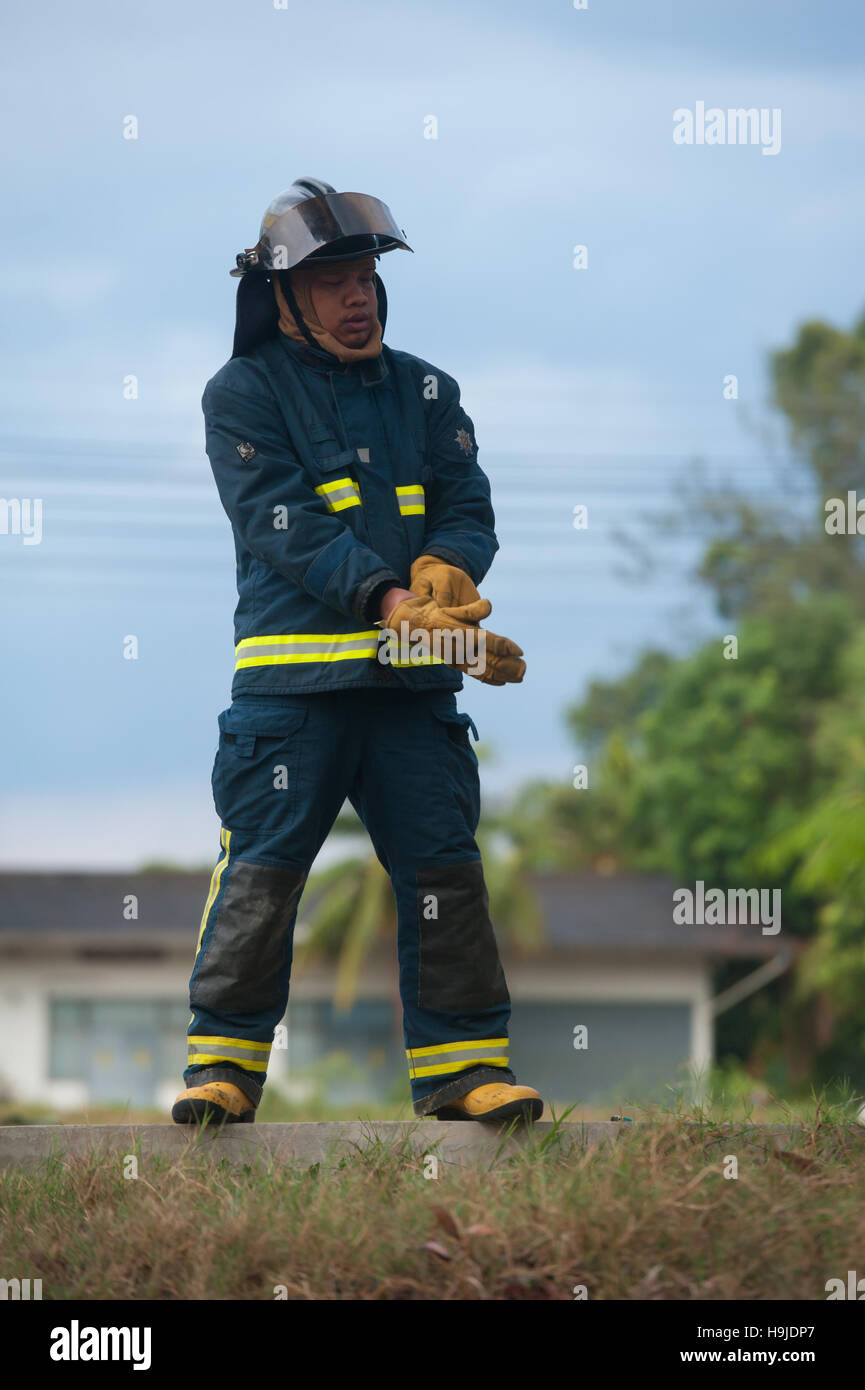 A firefighters dress their suit before the operating Stock Photo - Alamy