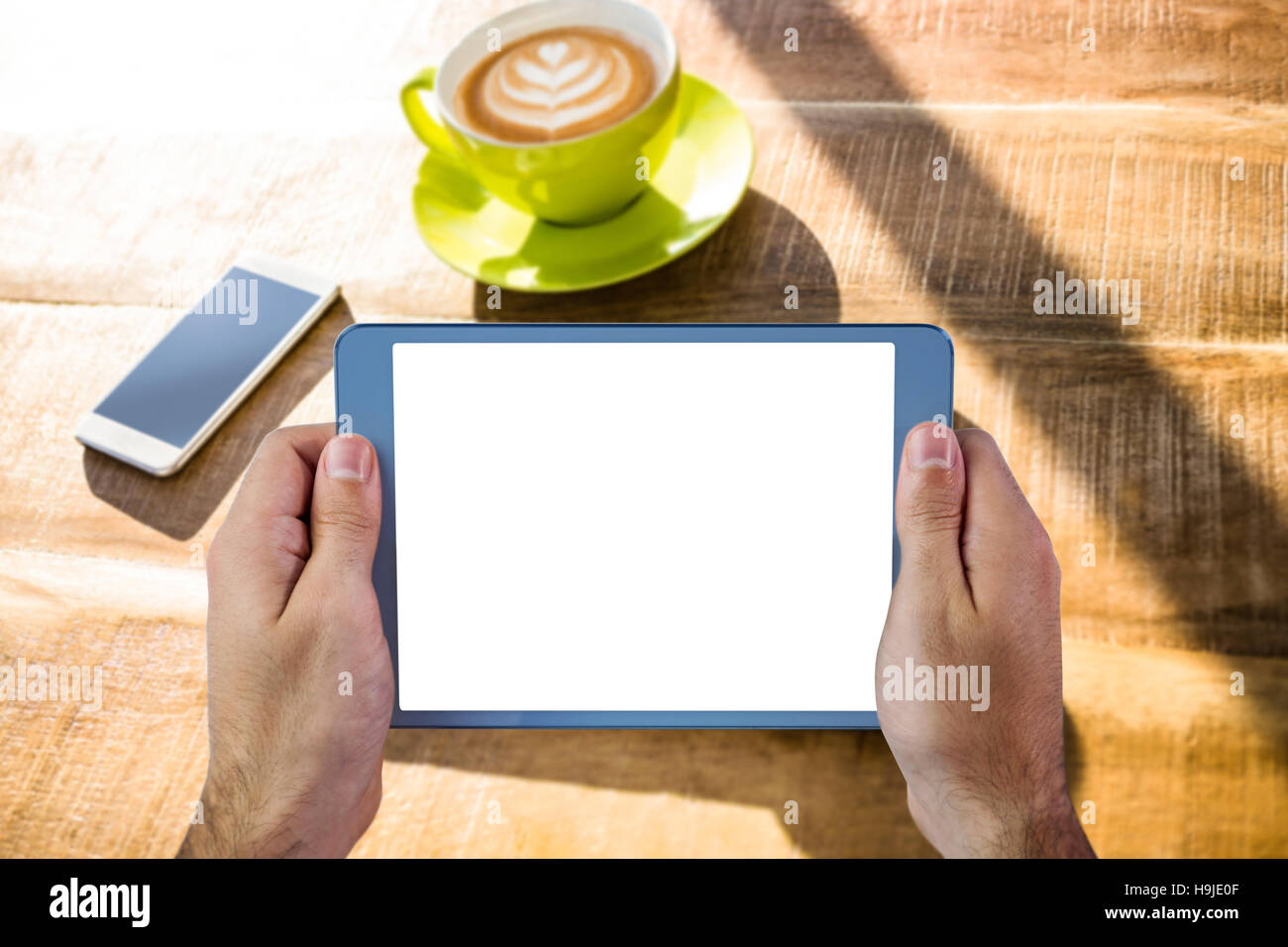 Composite image of cropped image of person holding tablet Stock Photo ...