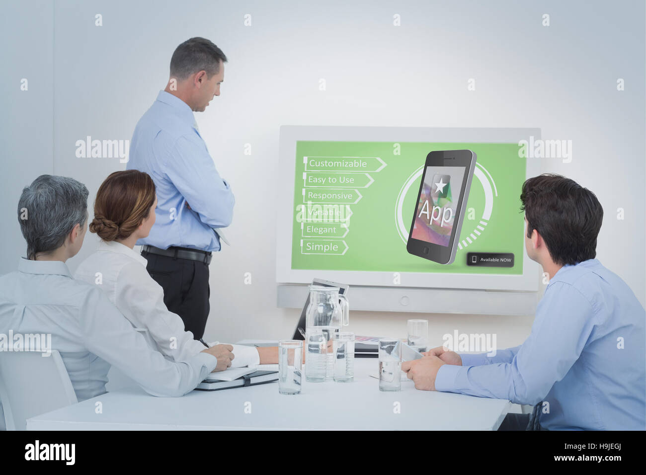 Composite image of business team looking screen Stock Photo - Alamy