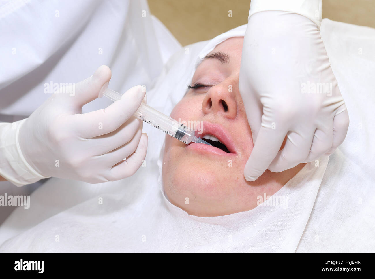 Woman gets anesthetic injection in mouth Stock Photo - Alamy