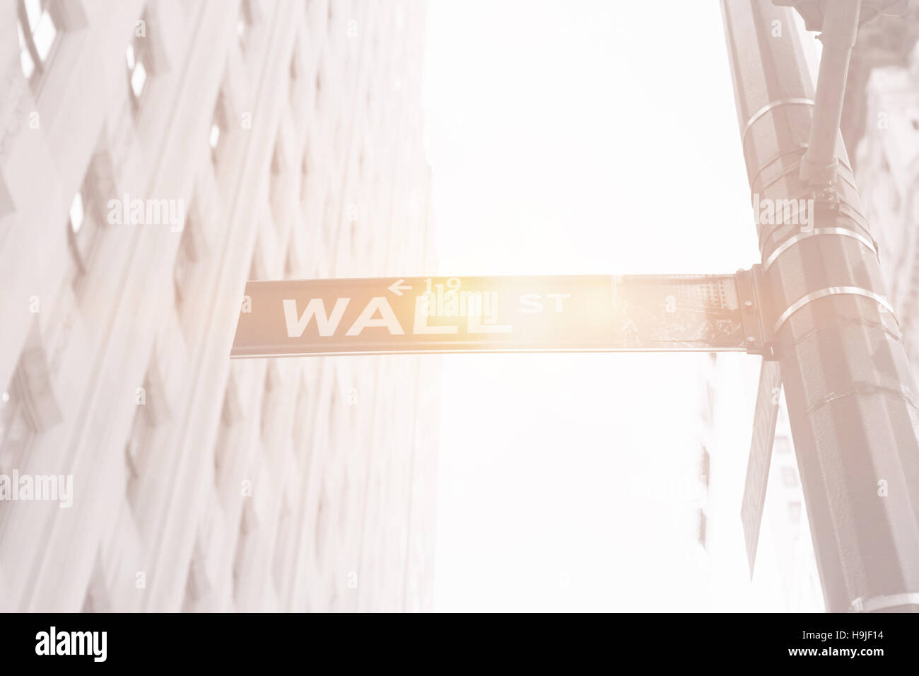 wall street sign with building and bright light Stock Photo - Alamy