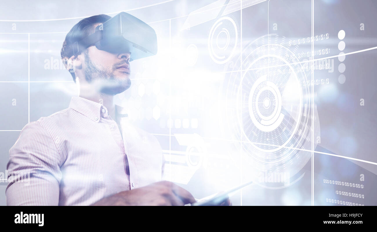 Composite image of man using an oculus and a tablet Stock Photo - Alamy
