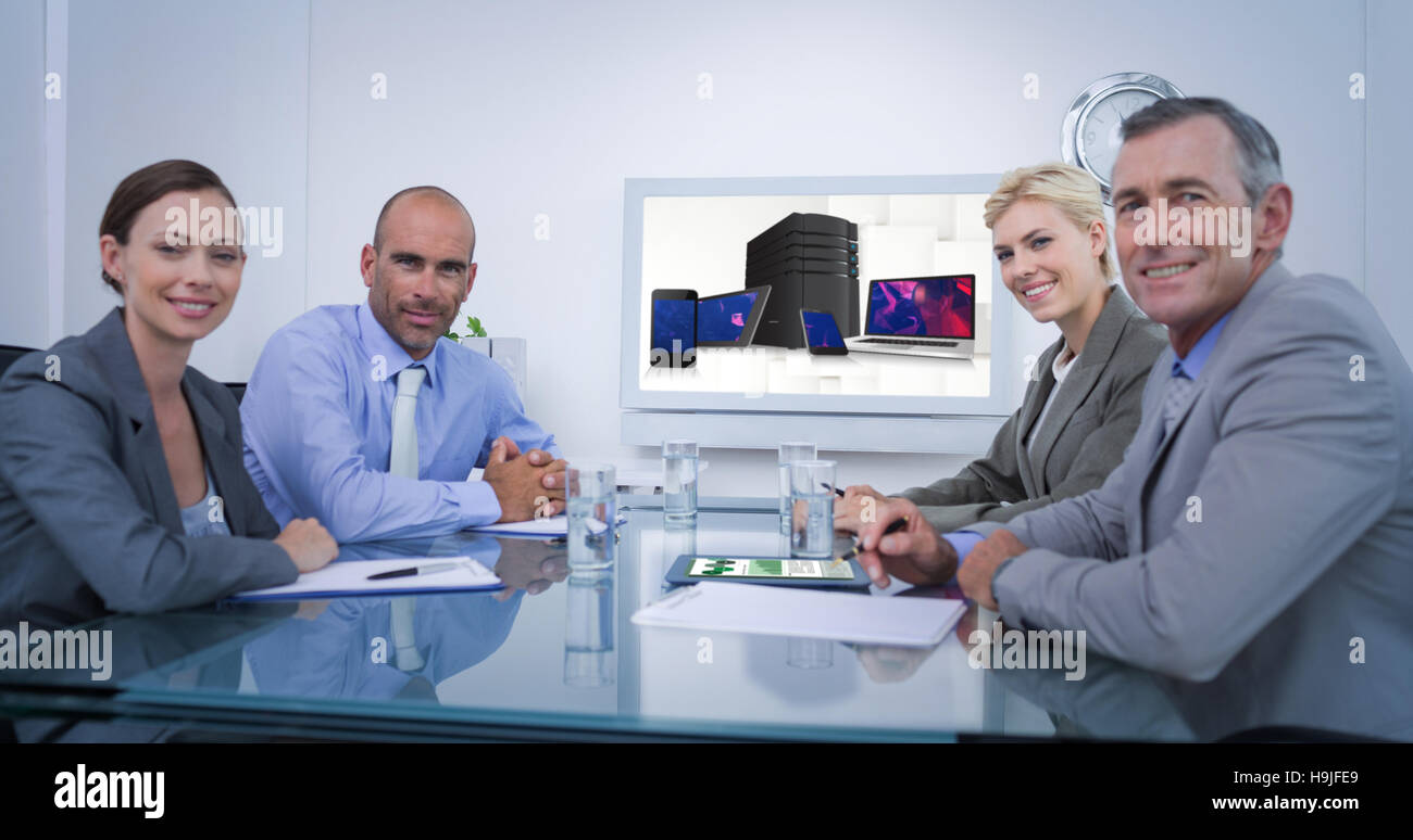 Composite image of business team looking at white screen Stock Photo ...