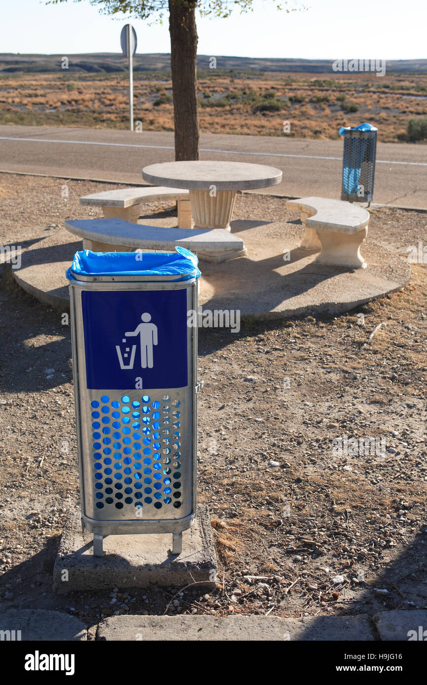 Dustbin and stone tables for picnic near road Stock Photo - Alamy