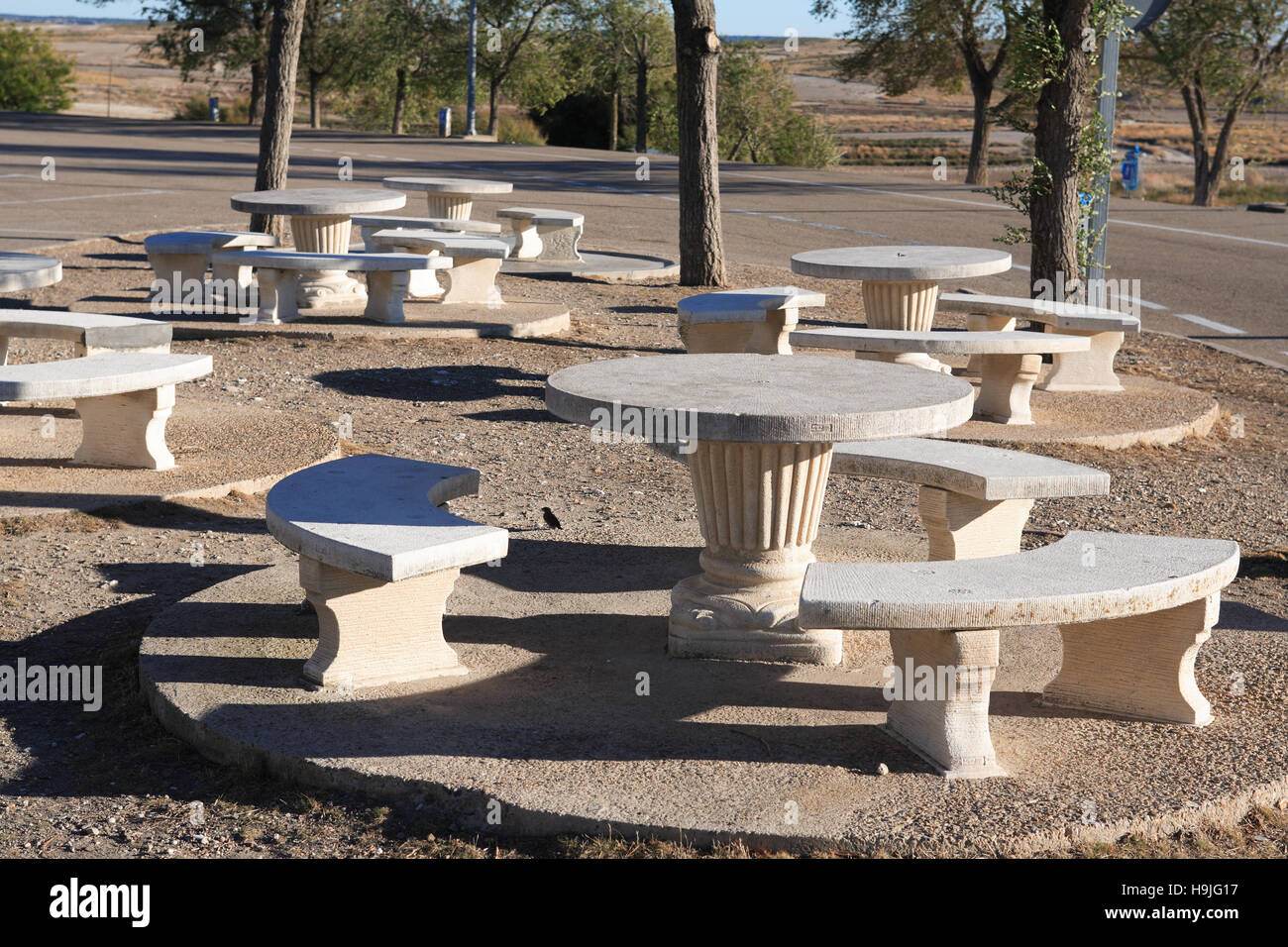 Picnic zone with stone benches and tables near highway Stock Photo - Alamy