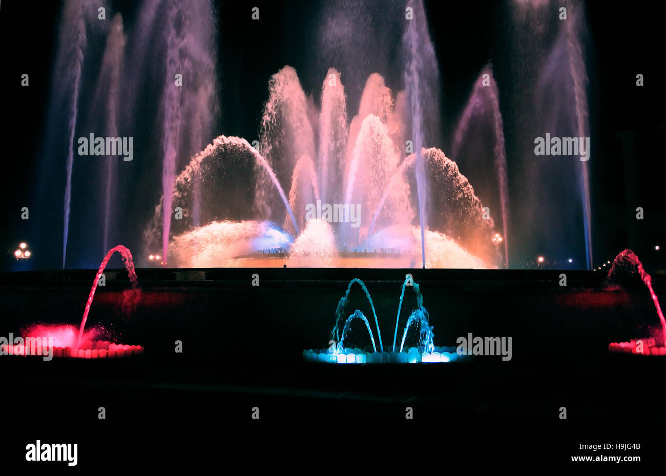 Holiday concept. Nice color fountain on dark background Stock Photo - Alamy