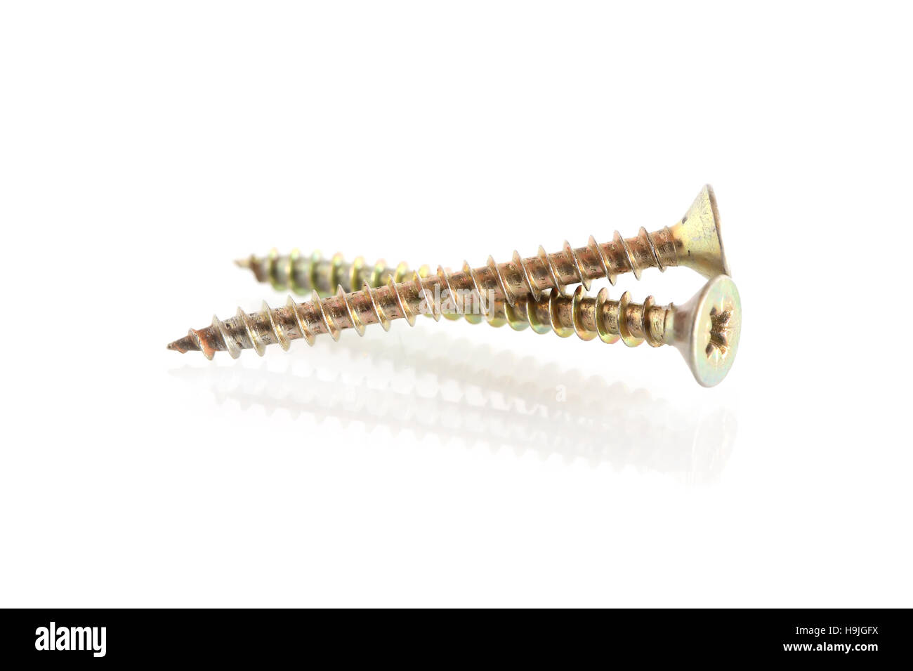 Two metal screws closeup on white background with reflection Stock ...