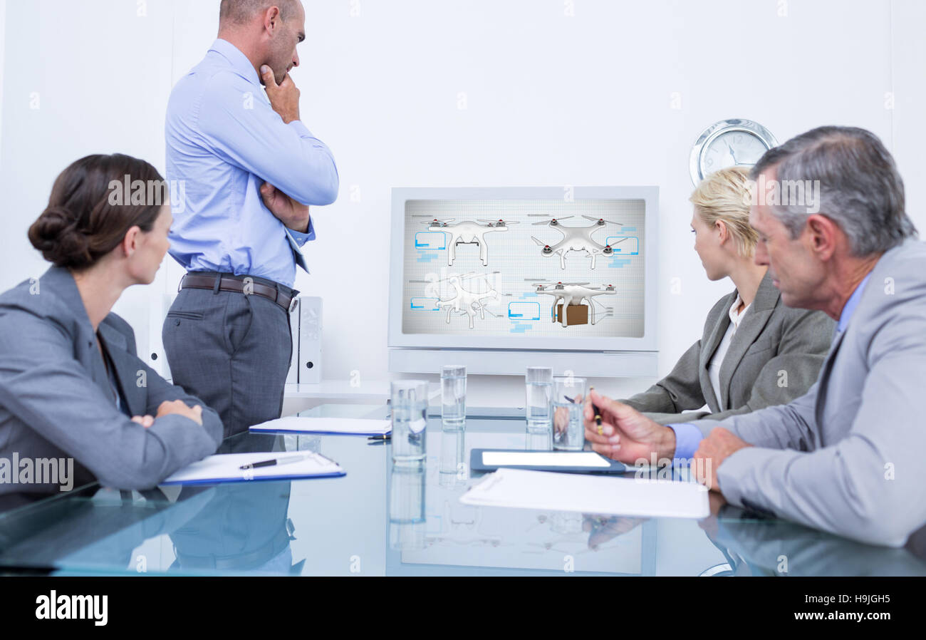 Composite image of business team looking at white screen Stock Photo ...