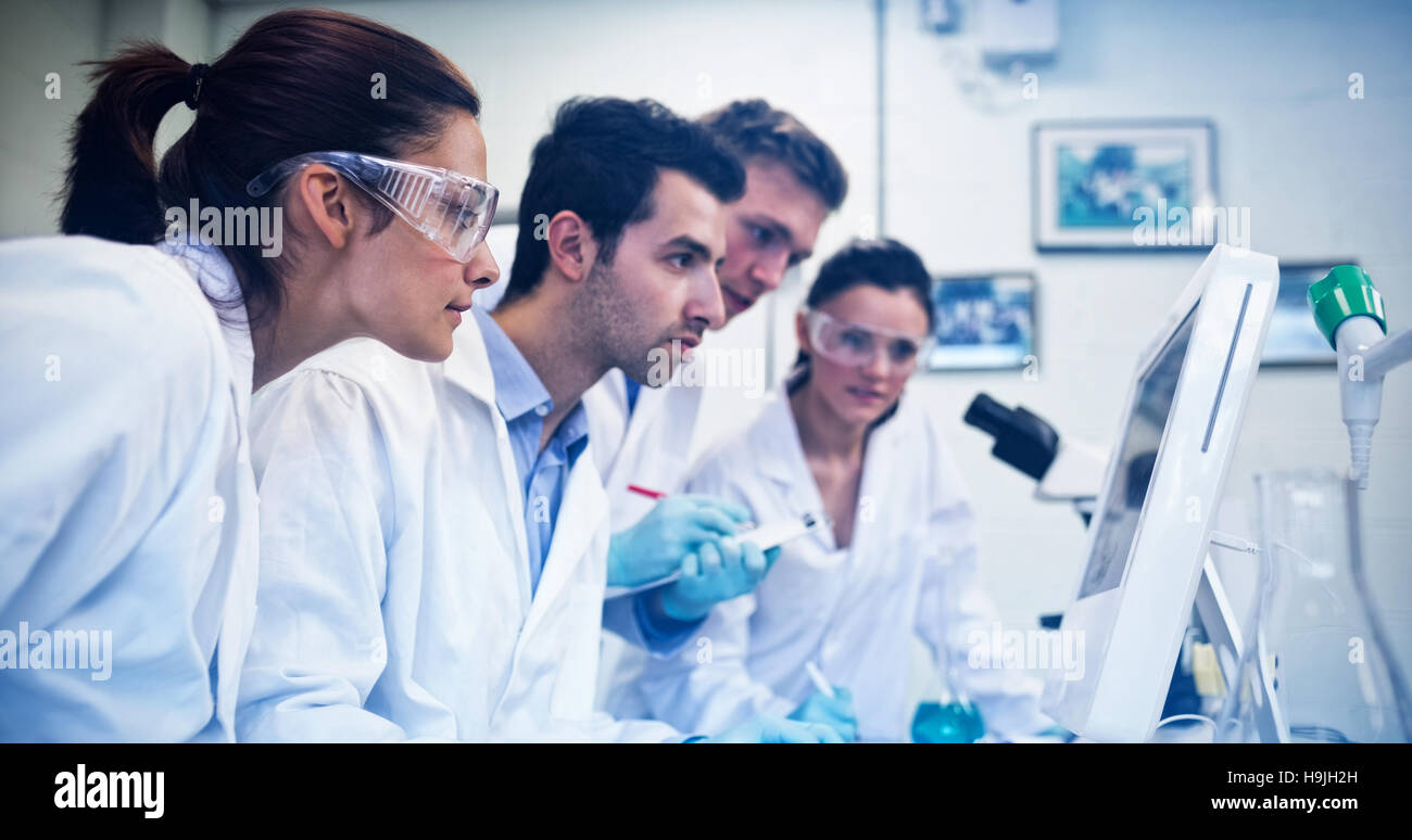 Serious researchers looking at computer screen in the lab Stock Photo ...