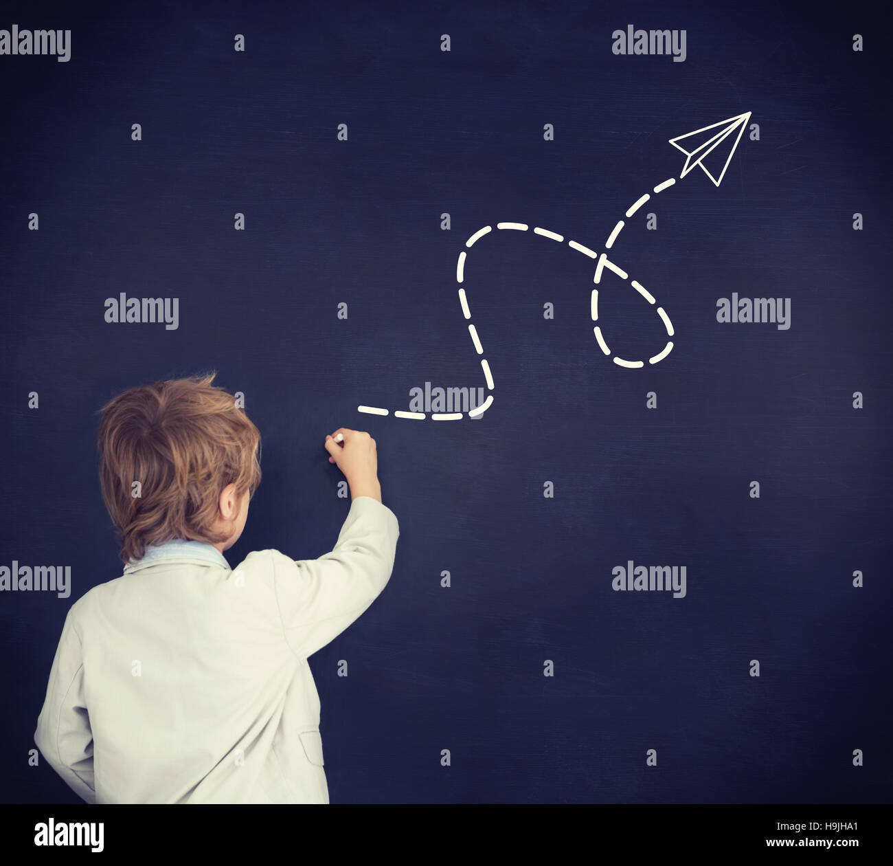 Composite image of cute pupil writing on board Stock Photo - Alamy