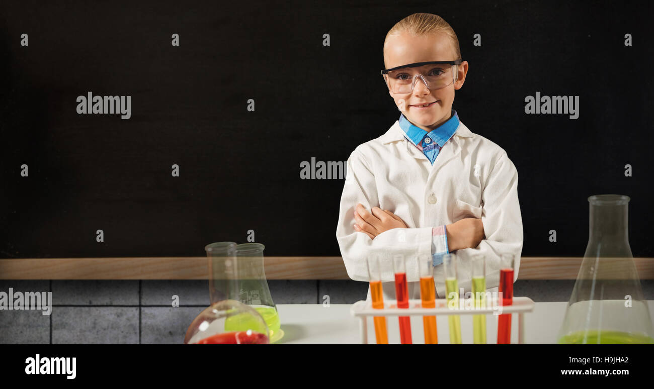 Composite image of boy standing in front of table with laboratory ...