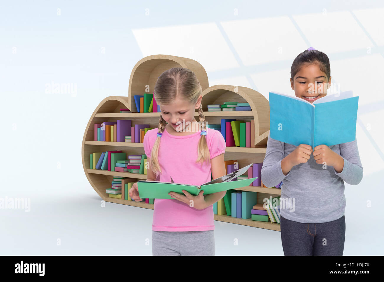 Composite image of elementary pupils reading Stock Photo - Alamy