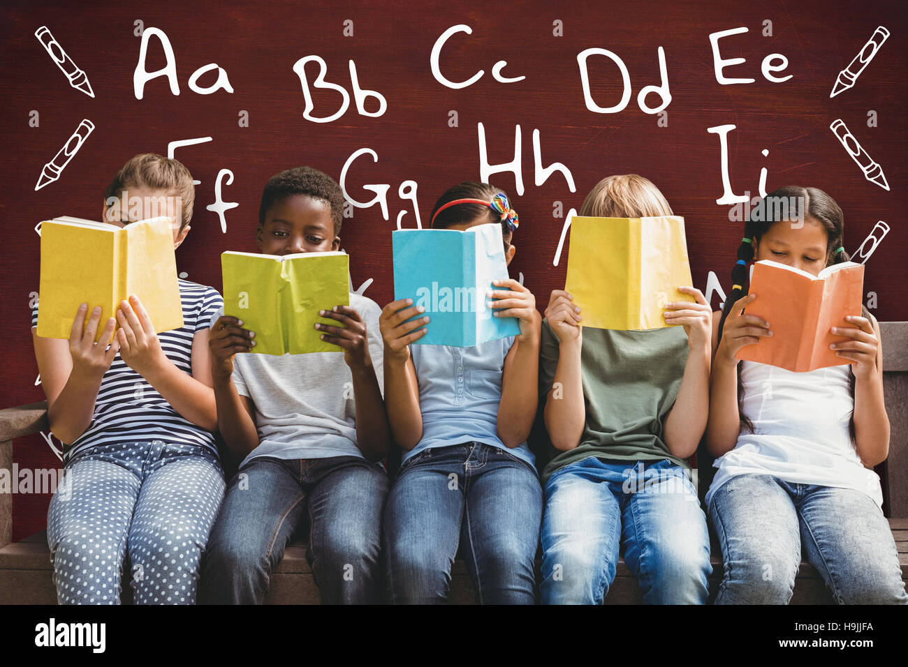 Composite image of children reading books at park Stock Photo - Alamy