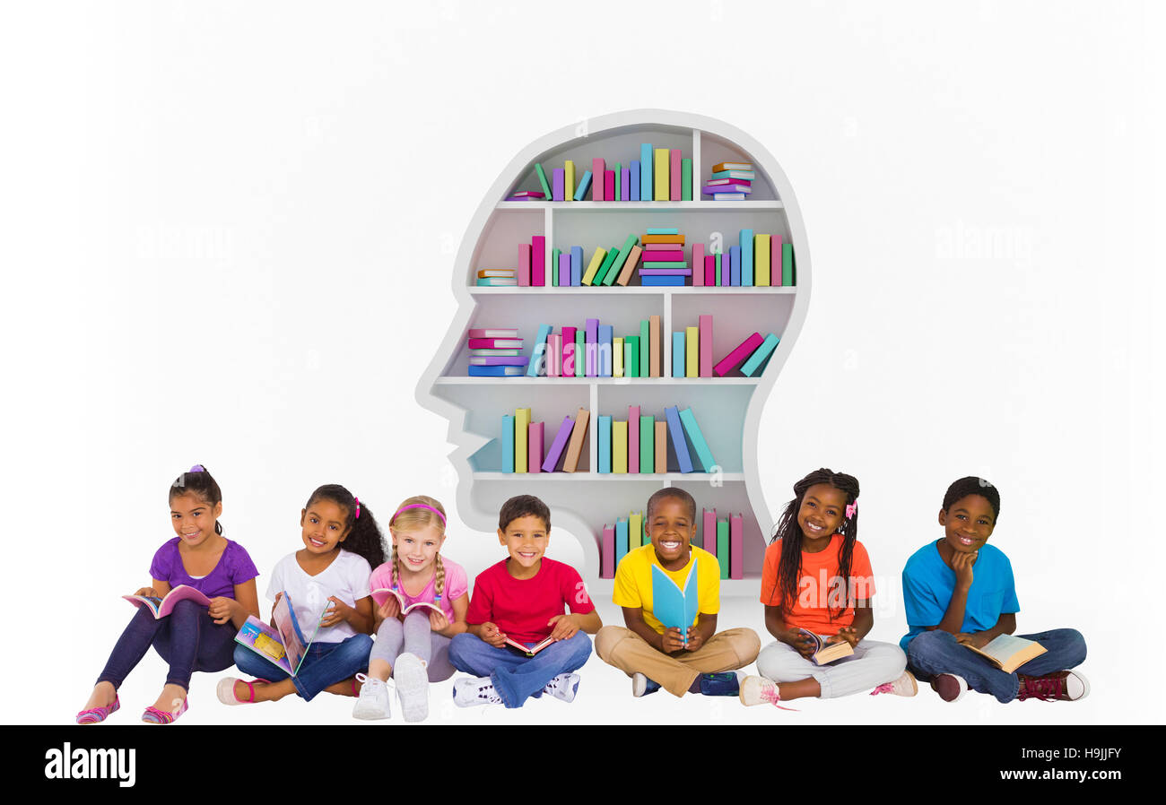 Composite image of elementary pupils reading books Stock Photo - Alamy