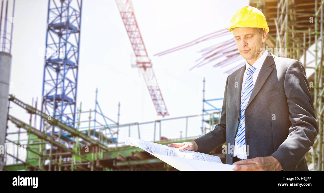 Composite image of architect holding blueprint Stock Photo - Alamy