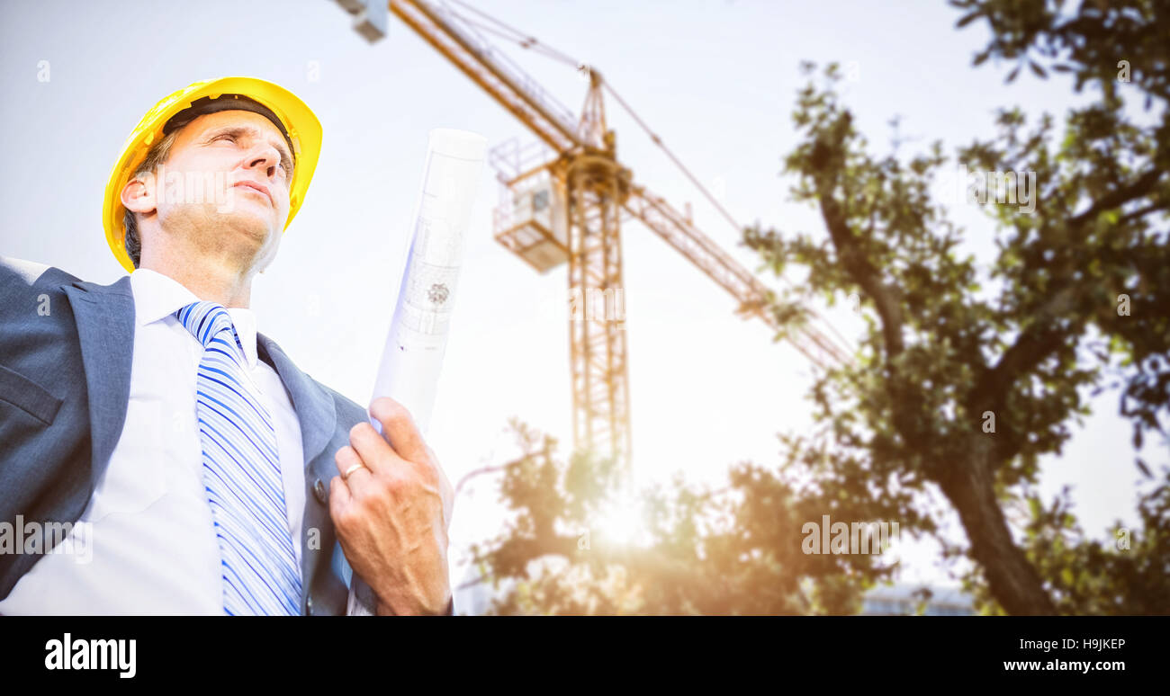 Composite image of low angle view of architect holding blueprint Stock ...