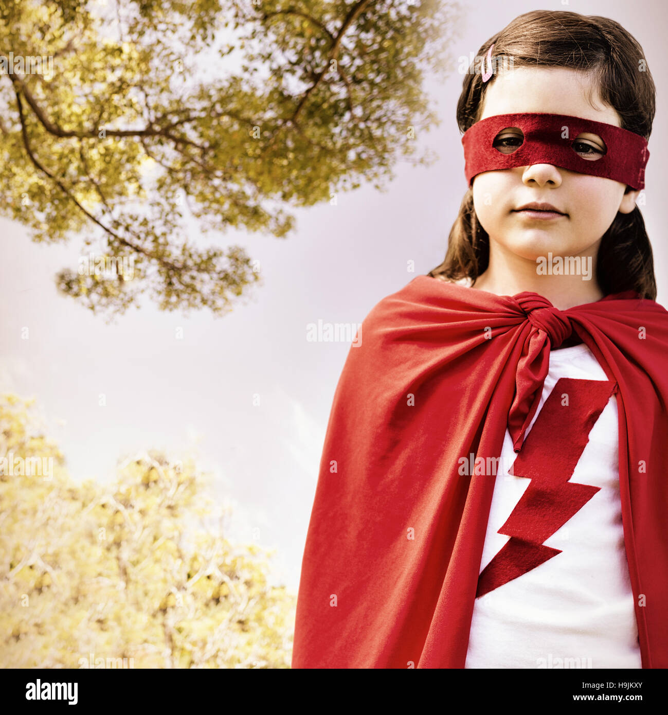 Composite image of portrait of girl in red eye mask and cape Stock ...