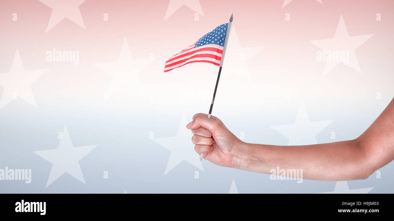 Cropped image of hand holding American flag Stock Photo - Alamy