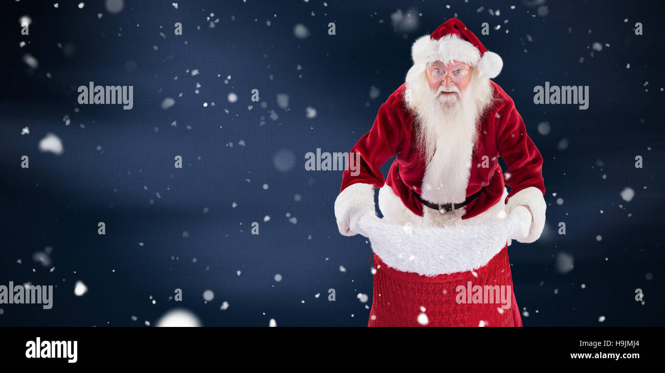 Composite image of santa open his red bag Stock Photo - Alamy