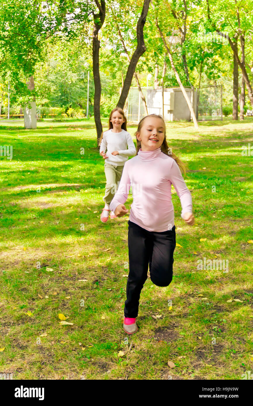 Photo of two running girls in summer Stock Photo - Alamy