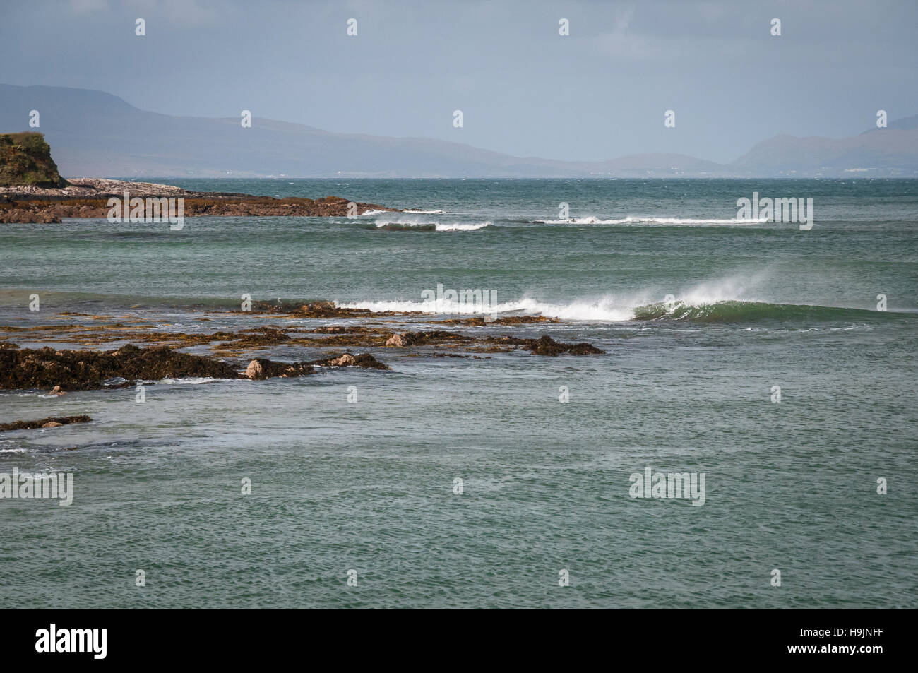 Wind blowing the surf off the top of the waves, County Mayo, Ireland ...