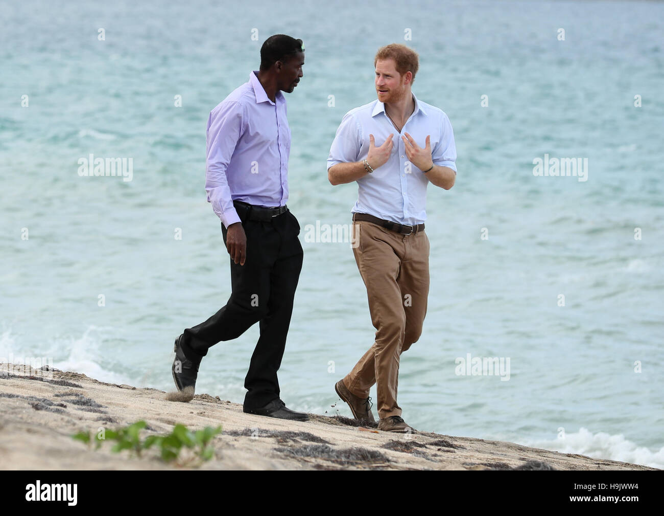 Prince Harry walks with Lemuel Pemberton from the Nevis Turtle Group on ...