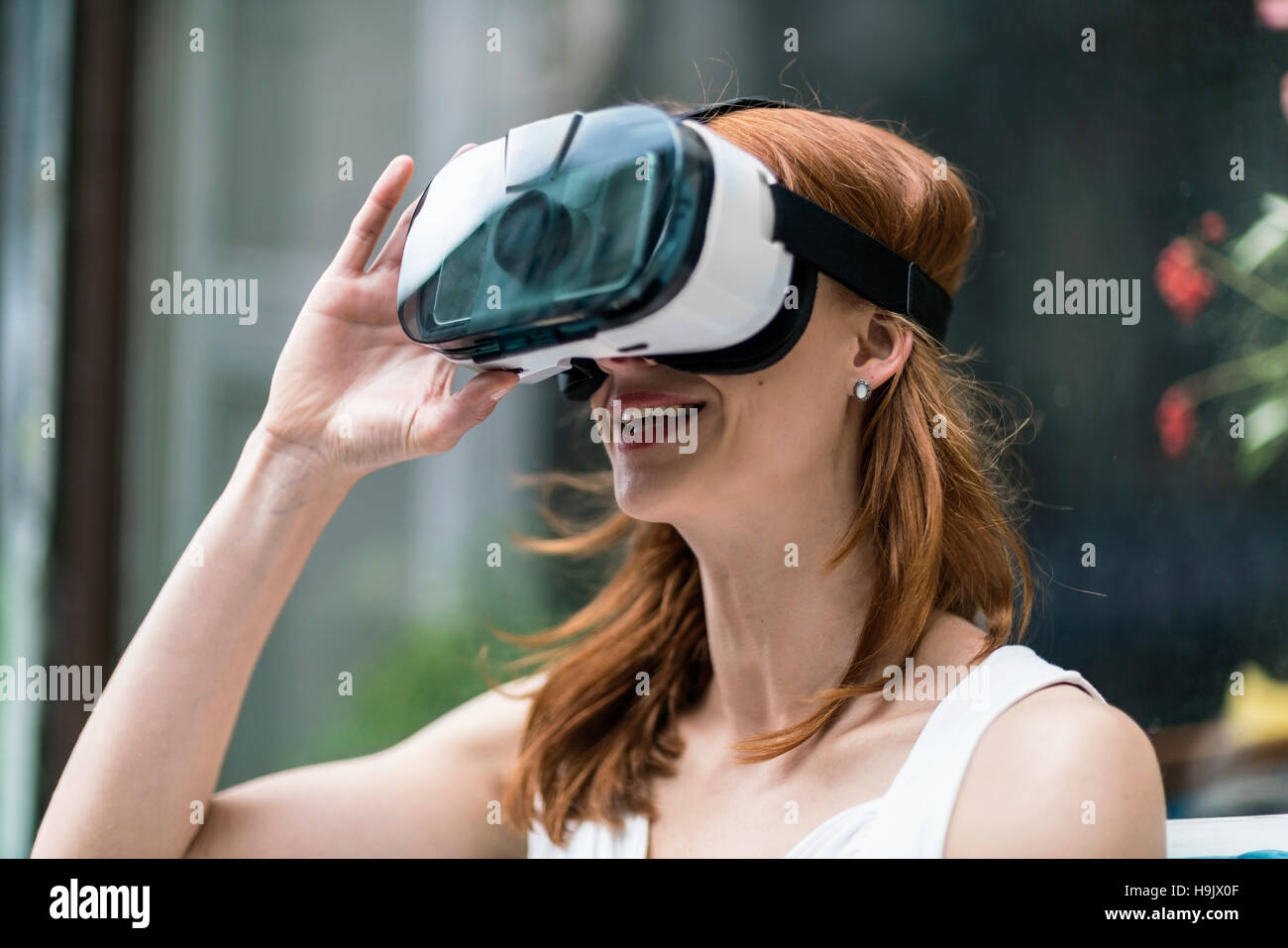 Redheaded woman wearing Virtual Reality Glasses Stock Photo - Alamy