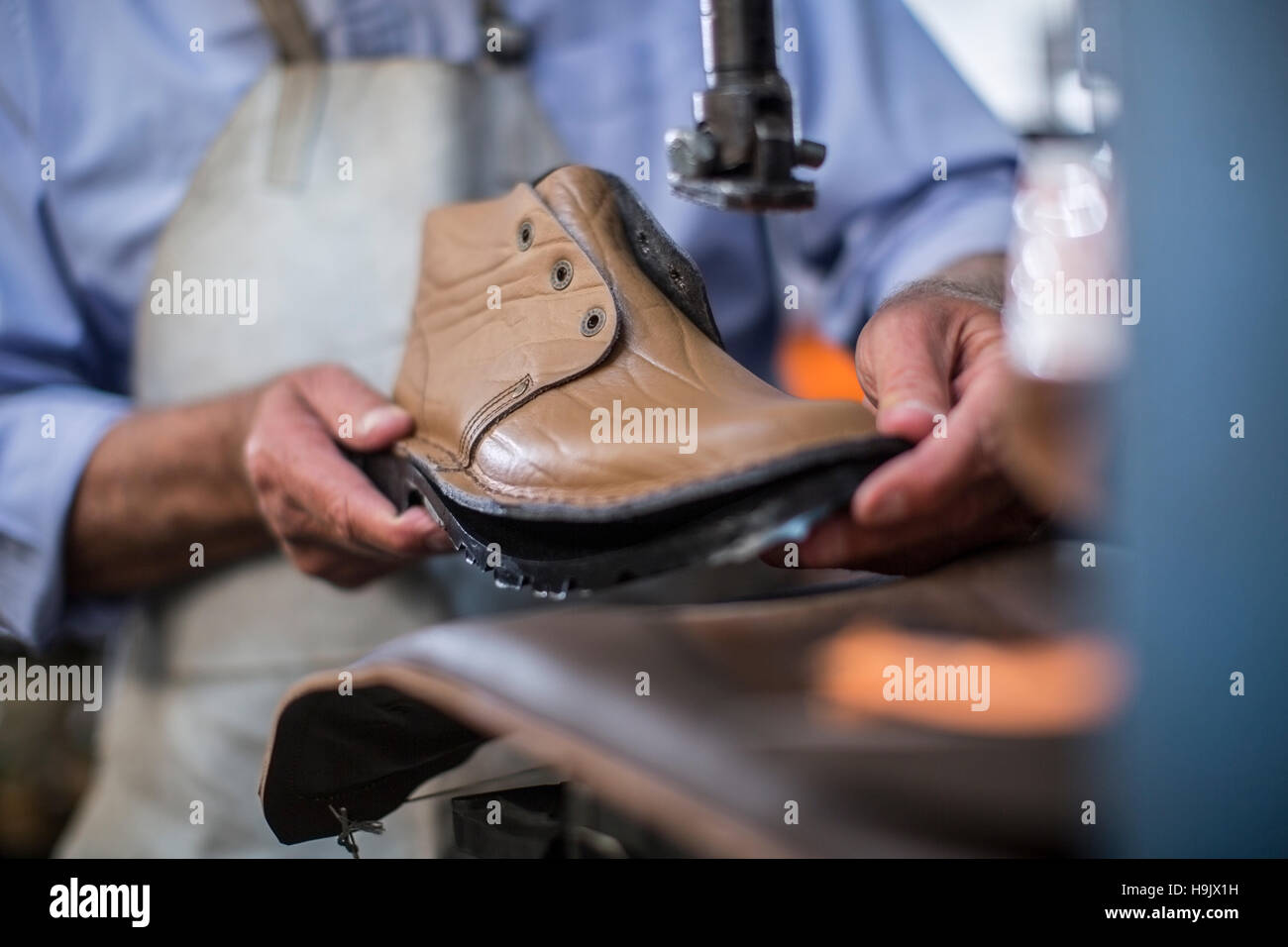 Shoemaker working on shoe in workshop Stock Photo - Alamy