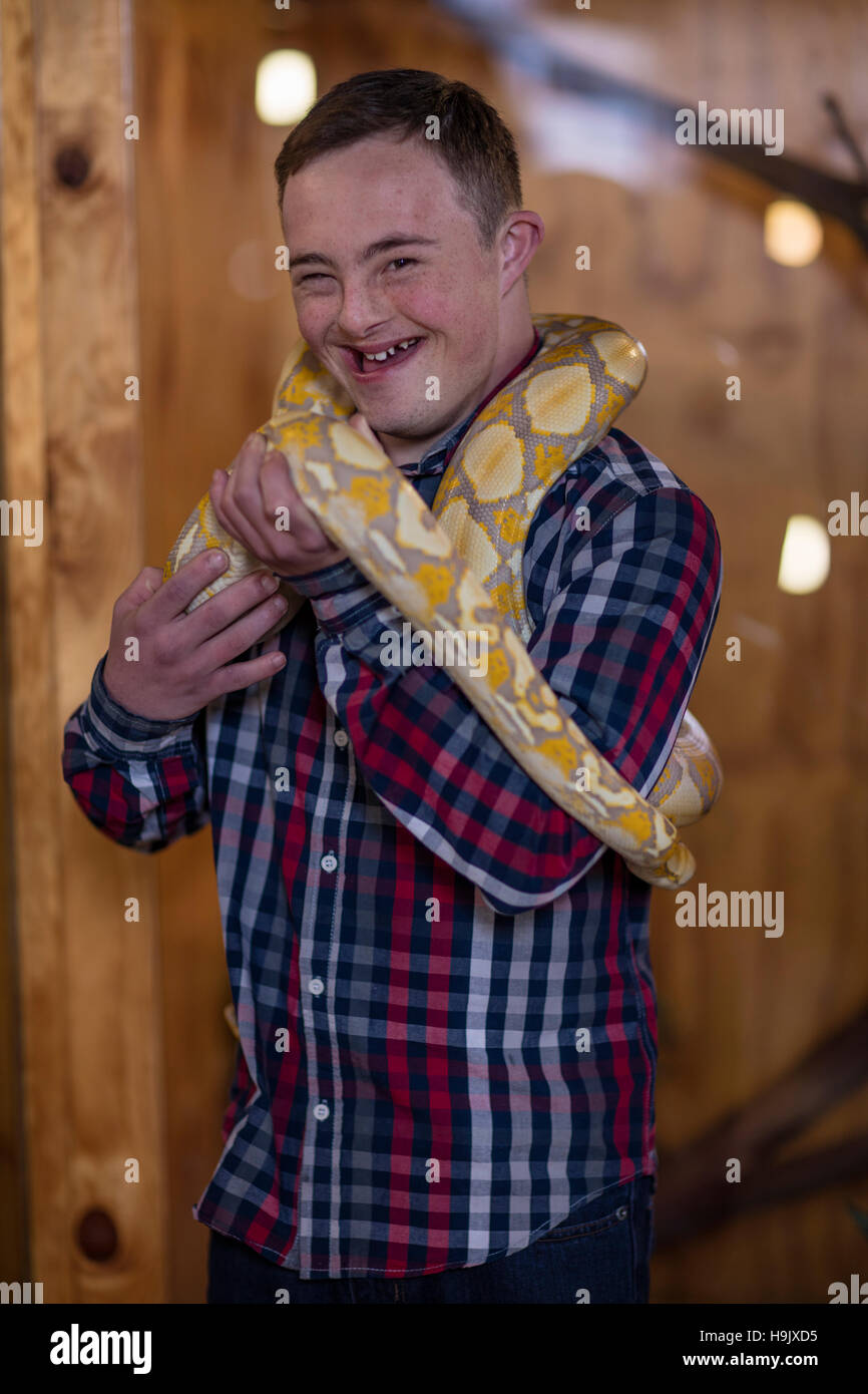 Young man with down syndrome holding albino python snake Stock Photo ...