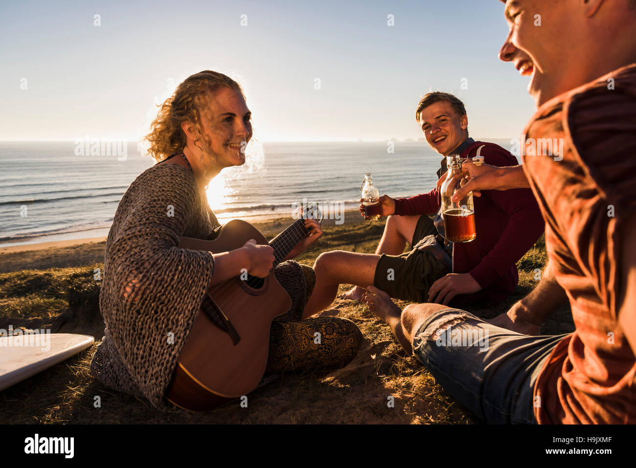 Three friends having fun at seaside Stock Photo - Alamy