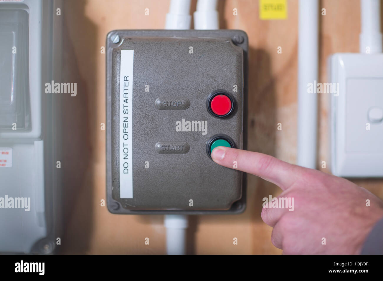 Hand turning on electrical control box Stock Photo - Alamy