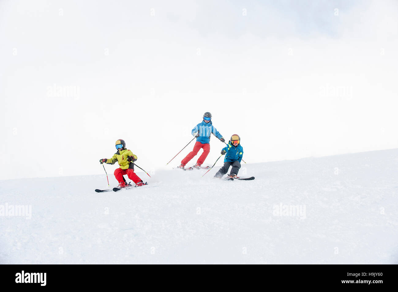 Father and two sons skiing together Stock Photo - Alamy