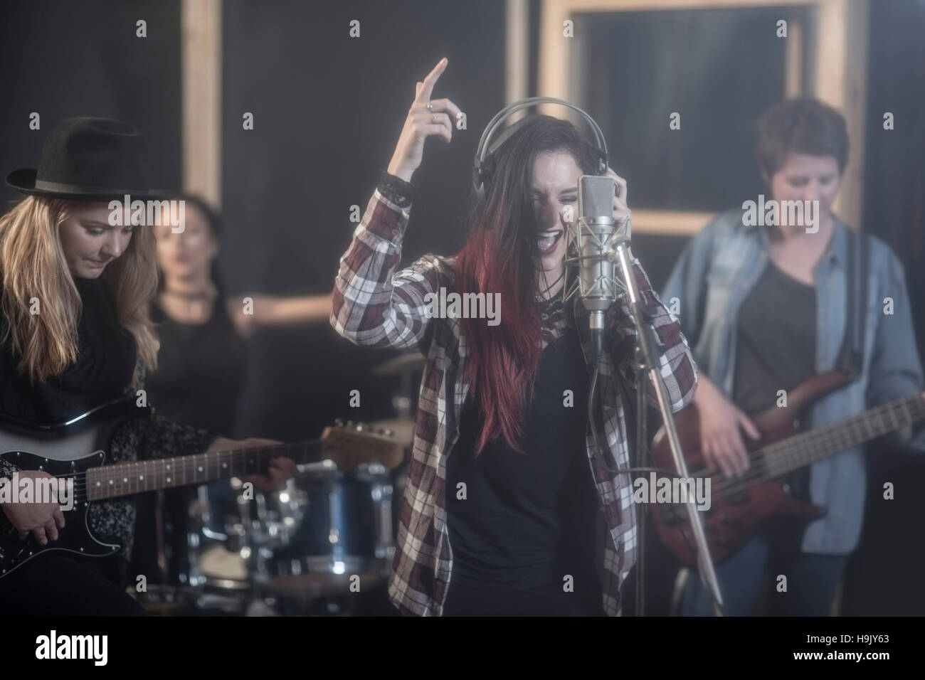 Female rock band in recording studio Stock Photo - Alamy