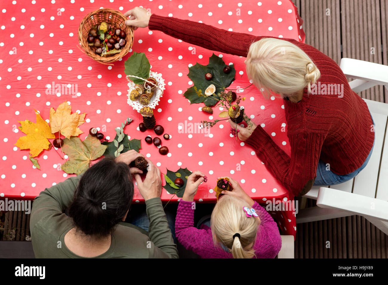 Top view of family tinkering chestnut figurines and autumnal decoration ...