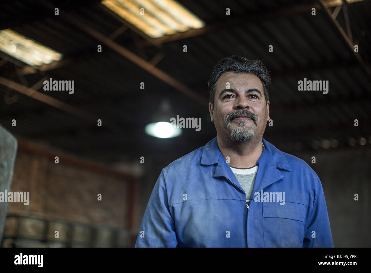 Portrait of confident worker in industrial factory Stock Photo - Alamy