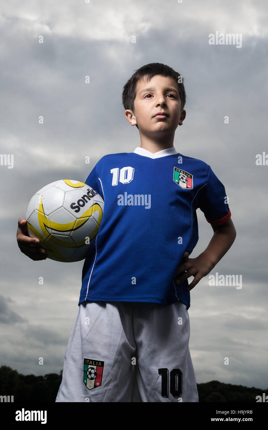 Boy holding a football Stock Photo - Alamy