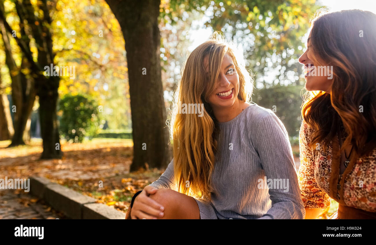 Two young women in a park in autumn Stock Photo - Alamy