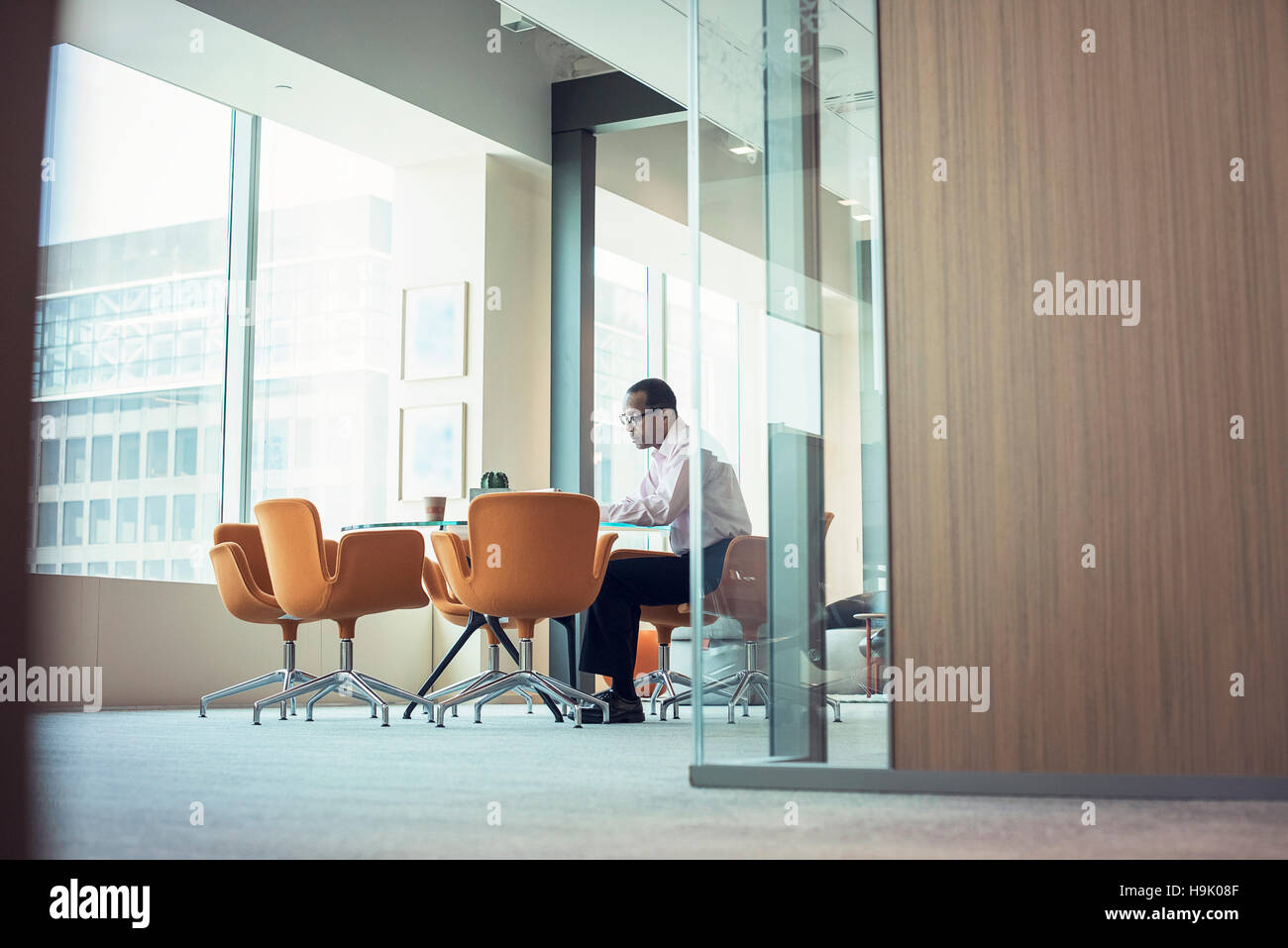 Businessman working alone in office Stock Photo - Alamy